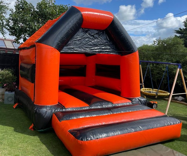 Shiny Orange & Black Bouncy Castle - Jolly Kids Castles, Essex